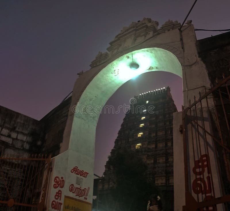 Low Angle Shot of Arch Gate with a Building in the Background at Night ...