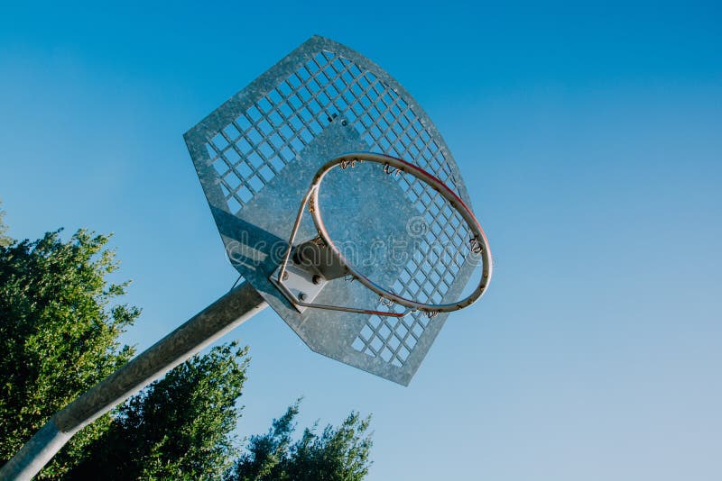 Low Angle Shot of a Basketball Hoop Under a Clear Blue Sky Stock Photo ...