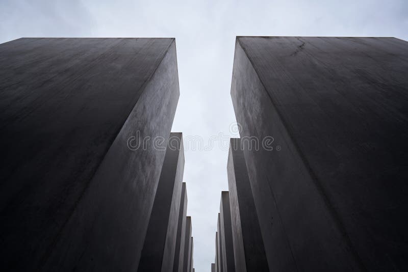 Low Angle Shot of Big Black Columns with a Cloudy Sky in Background ...