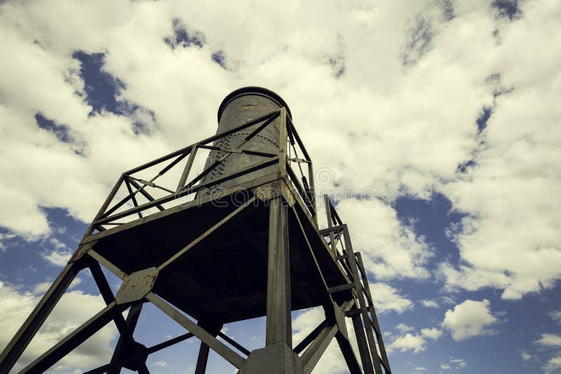 Low Angle Shot of a Black Water Tower Under a Cloudy Blue Sky Stock ...