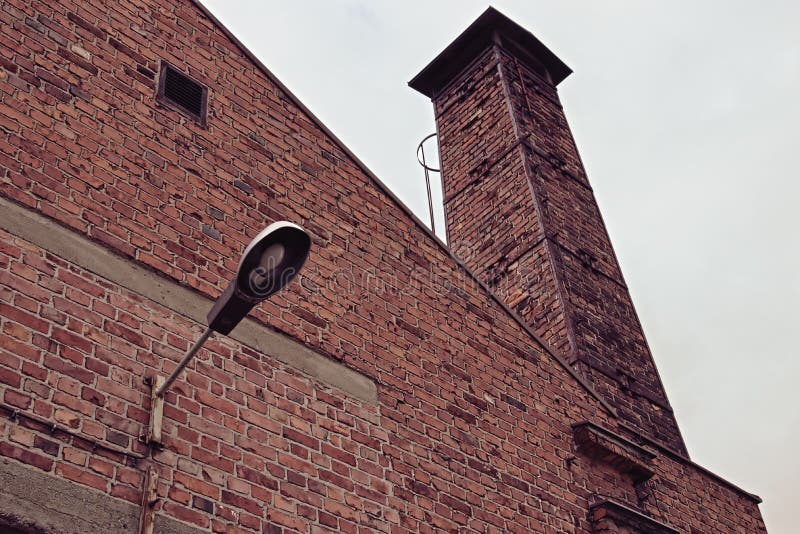 Low Angle Shot of a Brick Building with a Chimney and a Light on the ...