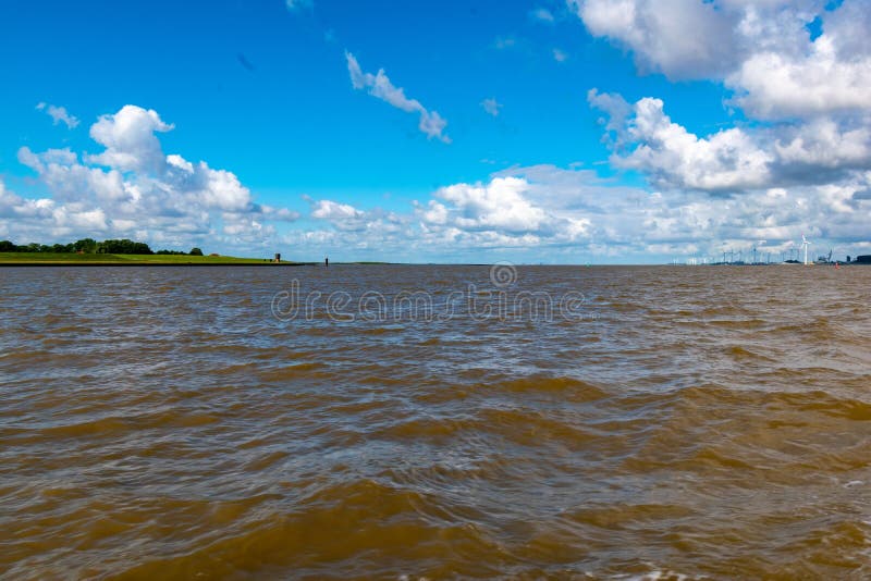 Low Angle Shot of a Brown Water Lake on a Cloudy Day Stock Photo ...