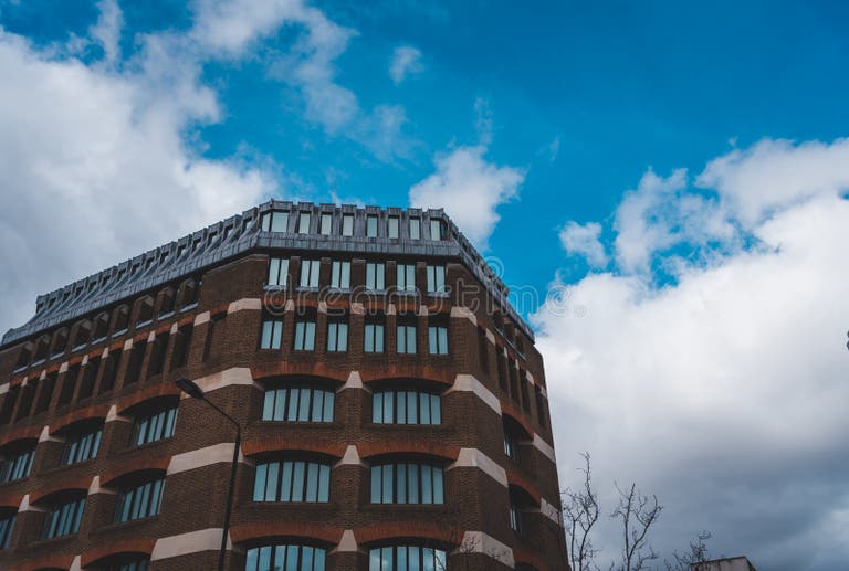 Low Angle Shot of a Building Under a Sky Full of Clouds Stock Photo ...