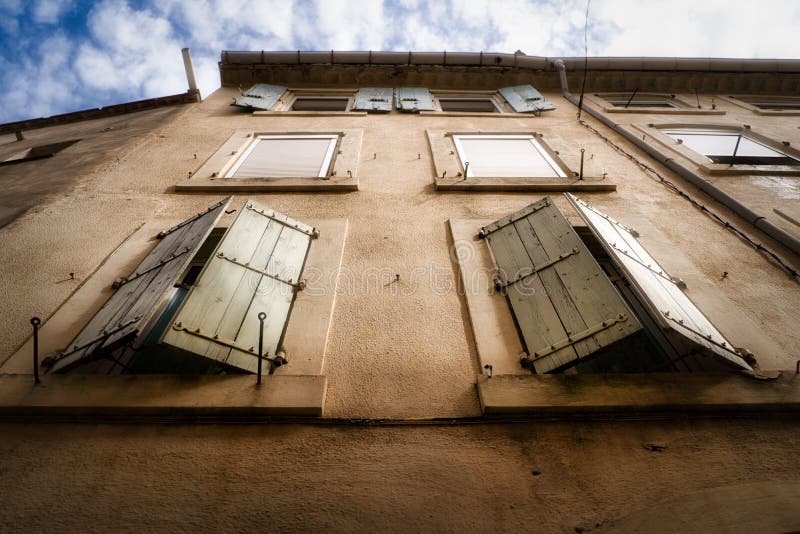 Low Angle Shot of a Building with Wooden Windows Stock Photo - Image of ...