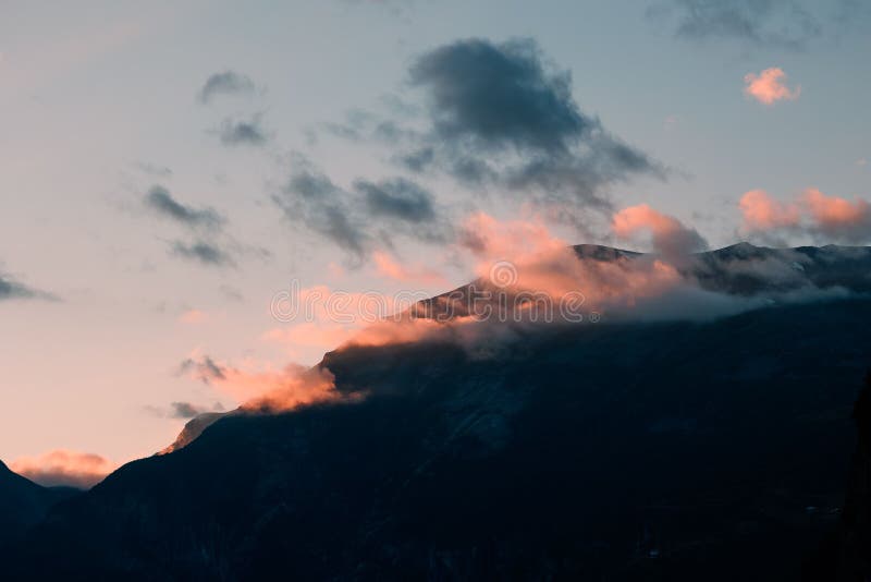 Low-angle Shot of Clouds Touching the Silhouette of a Mountain during ...