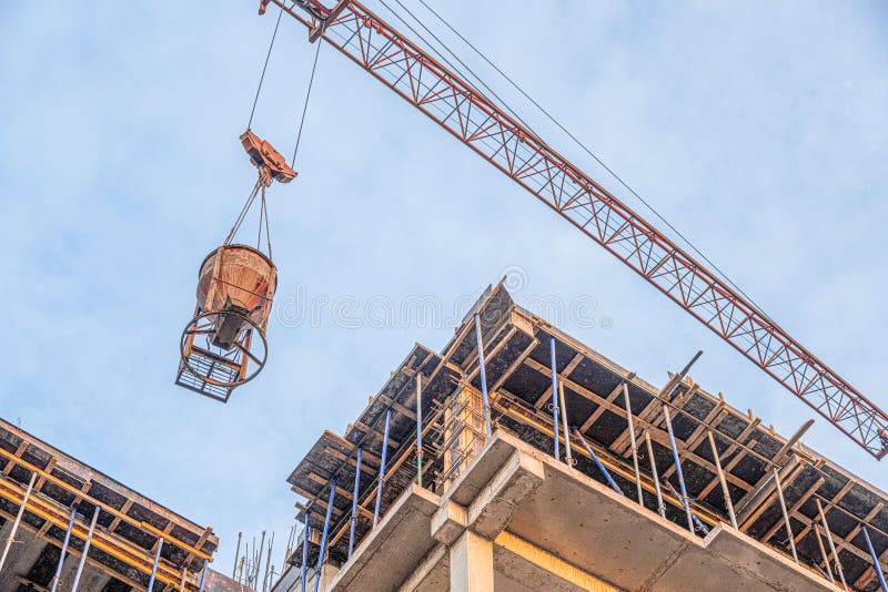 Low Angle Shot of a Crane with Equipment on a Construction Site with a ...