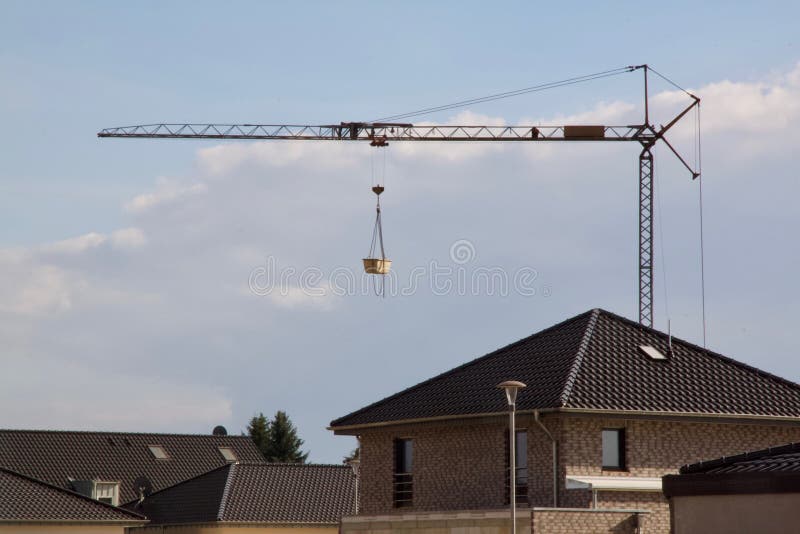 Low Angle Shot of a Crane Over a Houses Stock Photo - Image of building ...