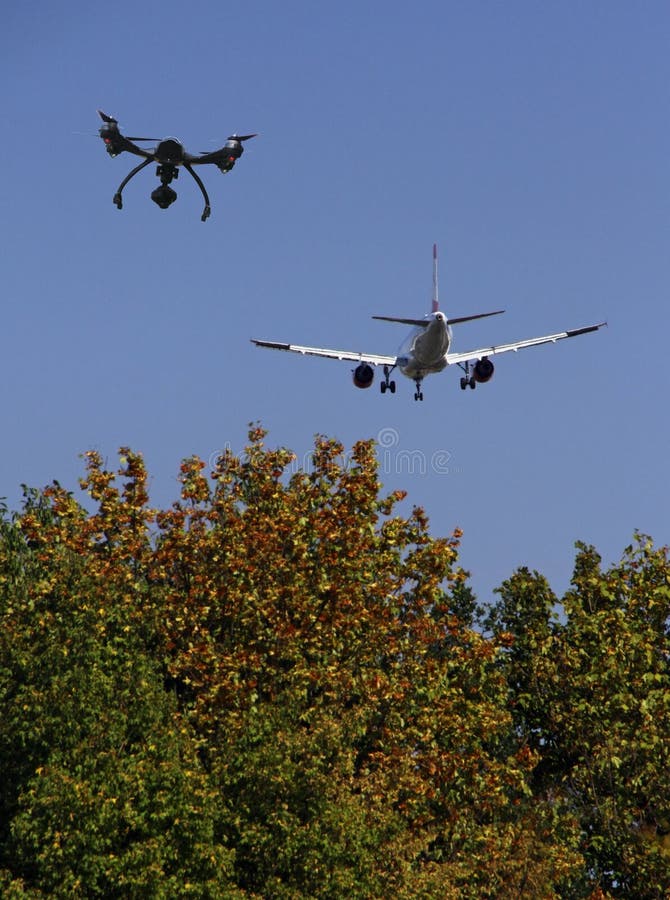 Low Angle Shot of a Drone and an Airplane Flying Next To Each Other ...