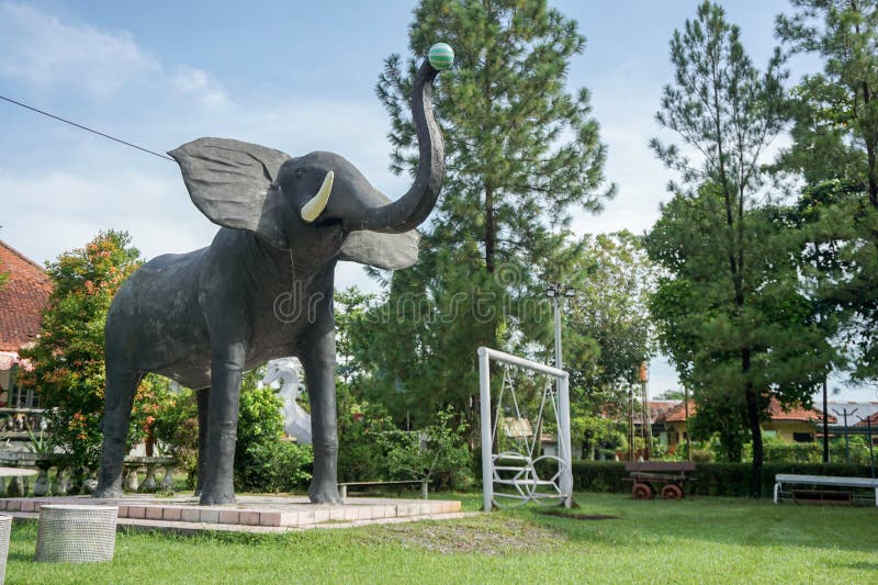 Low Angle Shot of an Elephant Figure in a Park with Negative Space on ...
