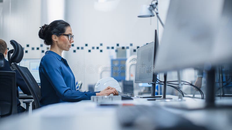 Low Angle Shot of a Female Engineer Working on Personal Computer. she ...