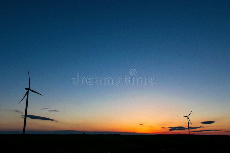 Low Angle Shot of a Field with Windmills during Sunset Stock Photo ...