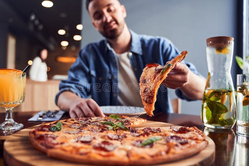 Low Angle Shot Guy with Beard Eating Pizza at Cafe Stock Photo - Image ...