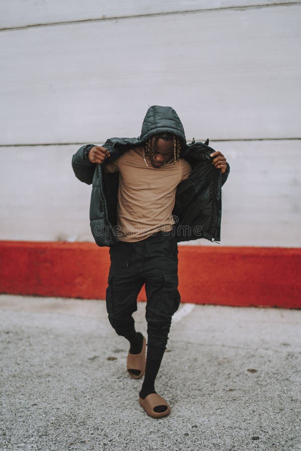 Low-angle Shot of a Handsome Stylish Spanish Man Posing on a Wall ...