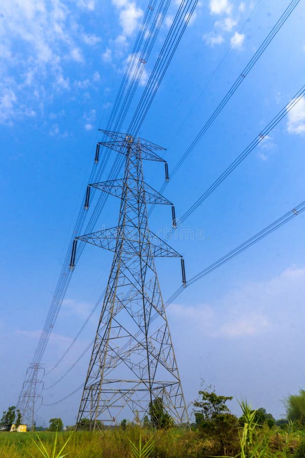 Low-angle Shot of a High Pipeline Pylon Electrical Network on a Blue ...