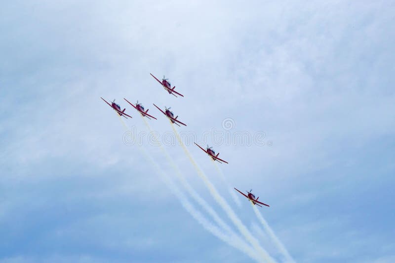 Low Angle Shot of Jet Team Performance in the Blue Cloudy Sky Stock ...