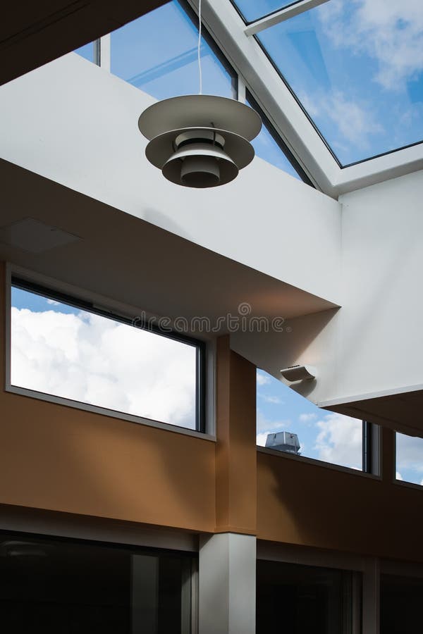 Low Angle Shot of a Lamp Hanging Inside a Building with a Glass Ceiling ...