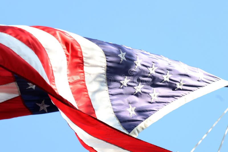 Low Angle Shot of a Large American Flag Waving in a Blue Sky Stock ...