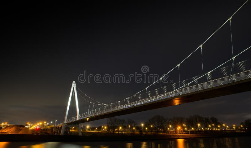 Low Angle Shot of a Large Bridge Going Over the Water at Night Stock ...