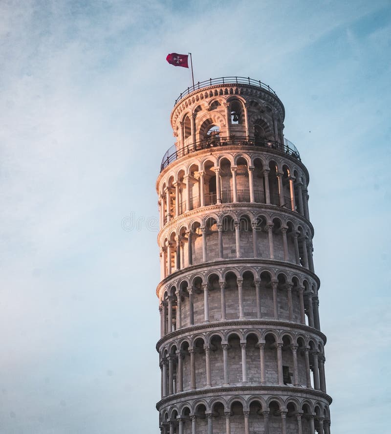 Low Angle Shot of the Leaning Tower of Pisa Under a Blue Cloudy Sky in ...