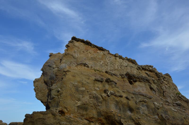 Low-angle Shot of a Massive Rock Cliff on the Blue Sky Background Stock ...