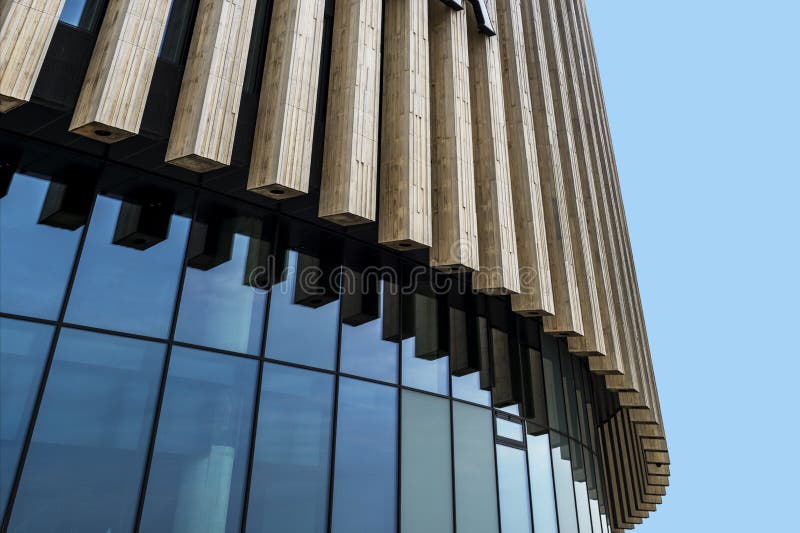 Low Angle Shot of a Modern Glass Building Covered with a Stone Curtain ...