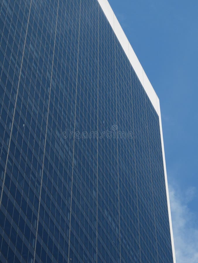 Low Angle Shot of a Modern Skyscraper with Square Windows Under the Sky ...