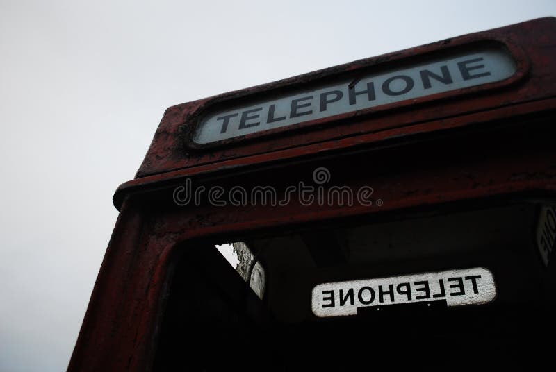 Low-angle Shot of an Old Red Call-box with an Inscription Telephone on ...