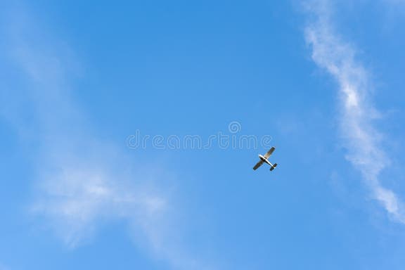 Low Angle Shot of a Plane Flying Under a Blue Sky Stock Photo - Image ...