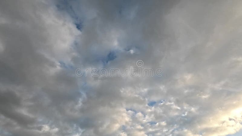 Low Angle Shot of the Puffy White Clouds Moving in the Blue Dusk Sky at ...