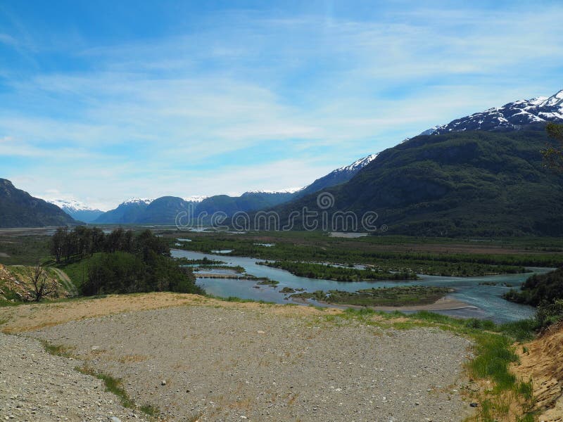 Low Angle Shot of a River, Grass, and Mountains Stock Image - Image of ...