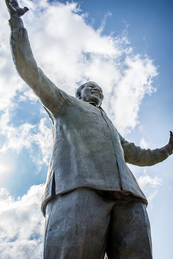 Low Angle Shot of the Statue of a Man Standing with Open Hands Under a ...