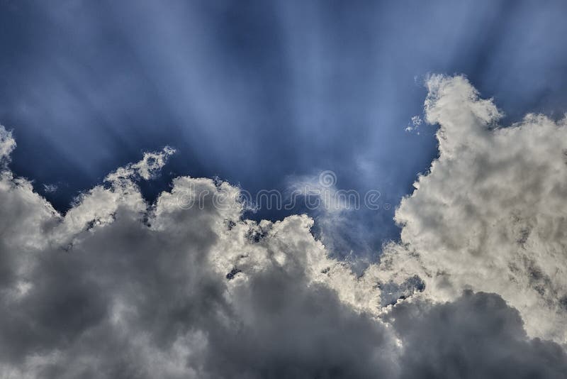 Low Angle Shot of the Sun Shining Behind the Clouds in a Blue Sky Stock ...