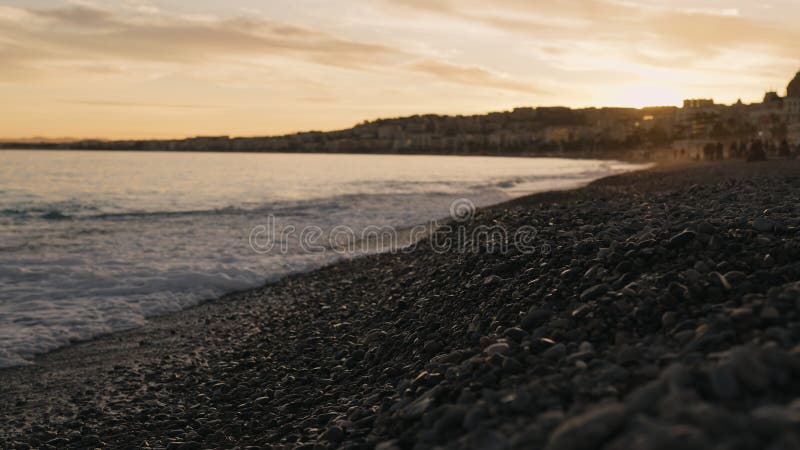 Low Angle Shot of Sunset on a Pebble Beach of Nice Stock Photo - Image ...