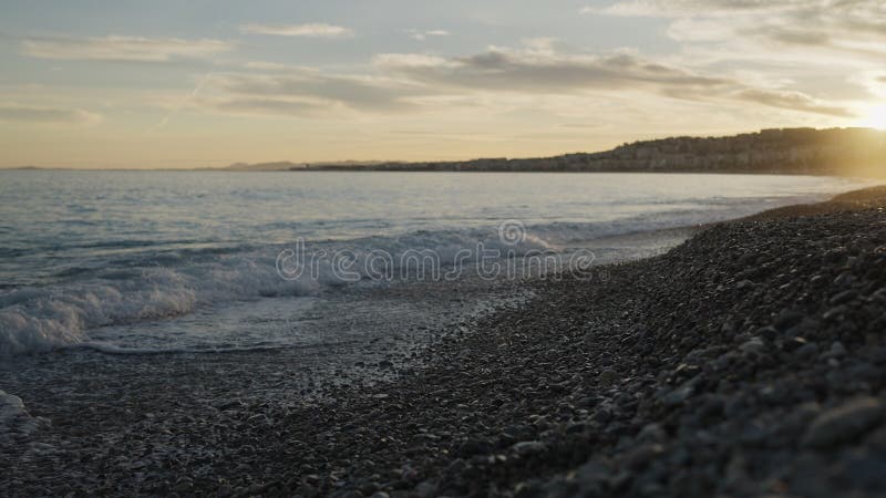 Low Angle Shot of Sunset on a Pebble Beach of Nice Stock Photo - Image ...