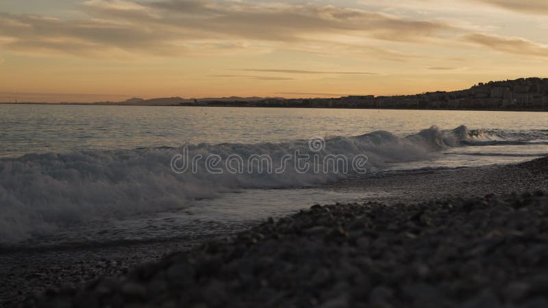 Low Angle Shot of Sunset on a Pebble Beach of Nice Stock Video - Video ...