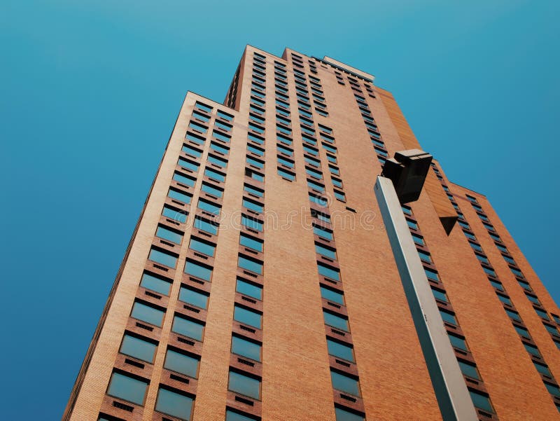 Low Angle Shot of a Tall Brick Building Under a Bright Blue Sky ...