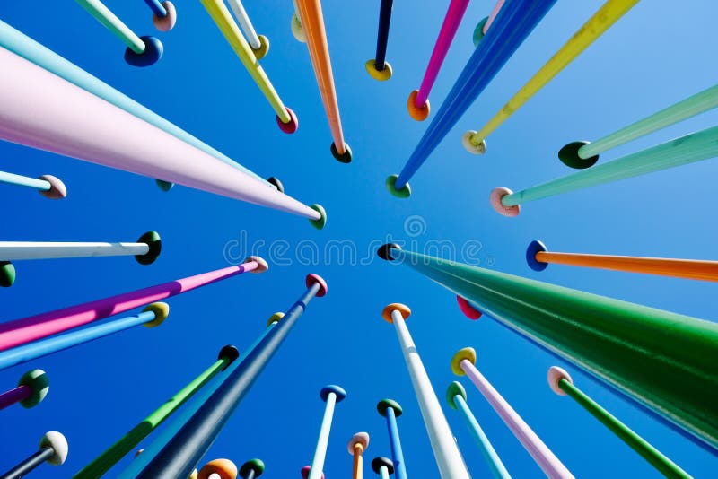 Low Angle Shot of Tall Colorful Poles in a Bright Blue Sky Stock Image ...