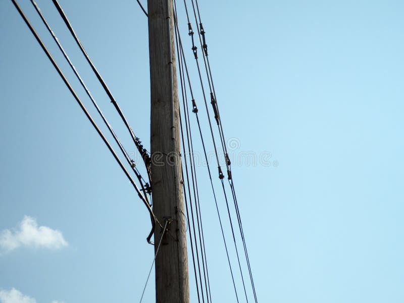 Low Angle Shot of a Tall Electric Post with a Lot of Cables Attached To ...