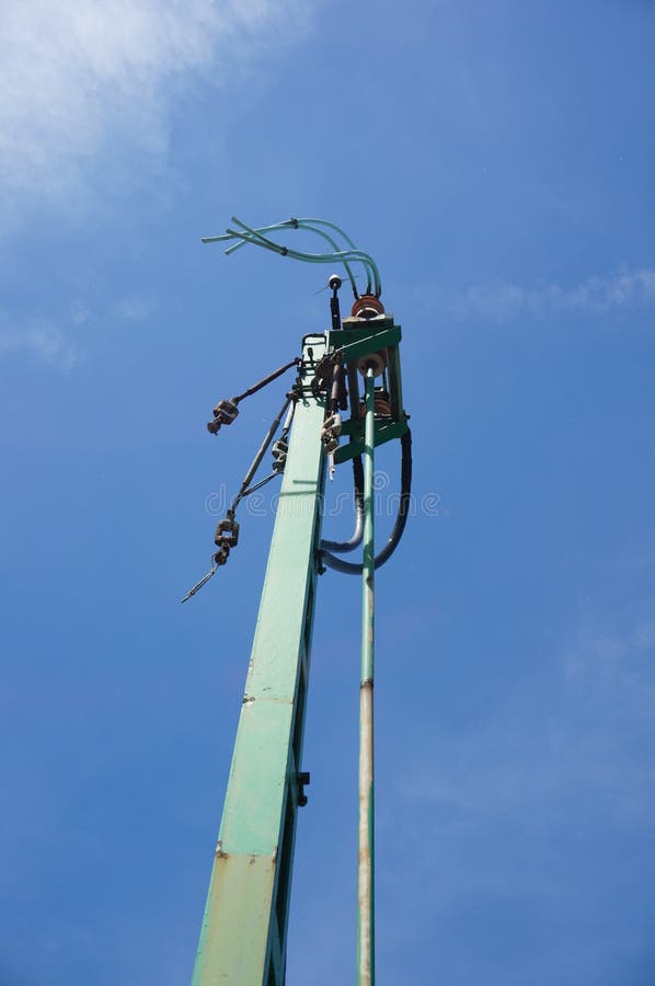 Low Angle Shot of a Tall Electricity Pole Under a Blue Sky Stock Image ...