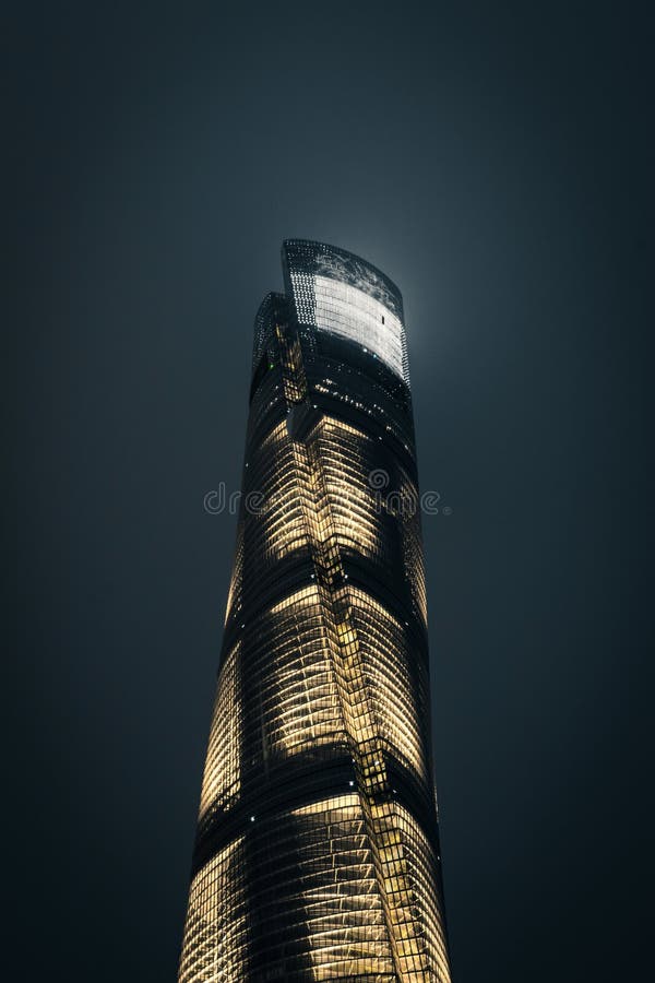 Low Angle Shot of a Tall Spiral Building Well Lit at Night with a Dark ...