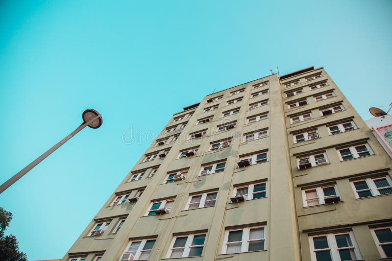 Low-angle Shot of a Tall Tan-colored Building with an Array of Windows ...