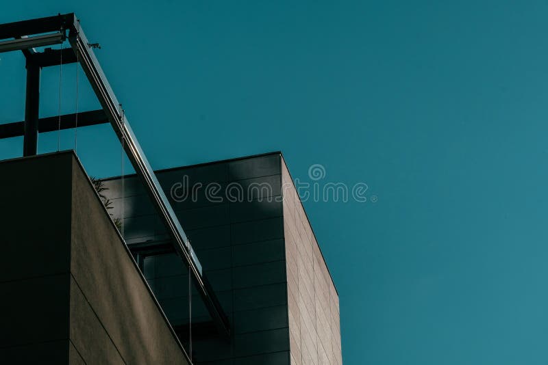 Low Angle Shot of the Top of the Modern Building with Clear Blue Sky in ...