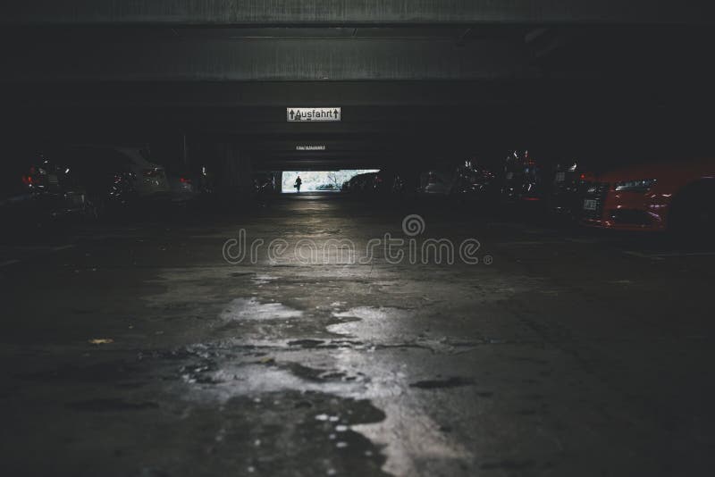 Low Angle Shot of an Underground Parking Lot with a Lot of Cars and an ...