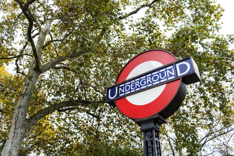 Low Angle Shot of the Underground Sign Surrounded by Trees Editorial ...