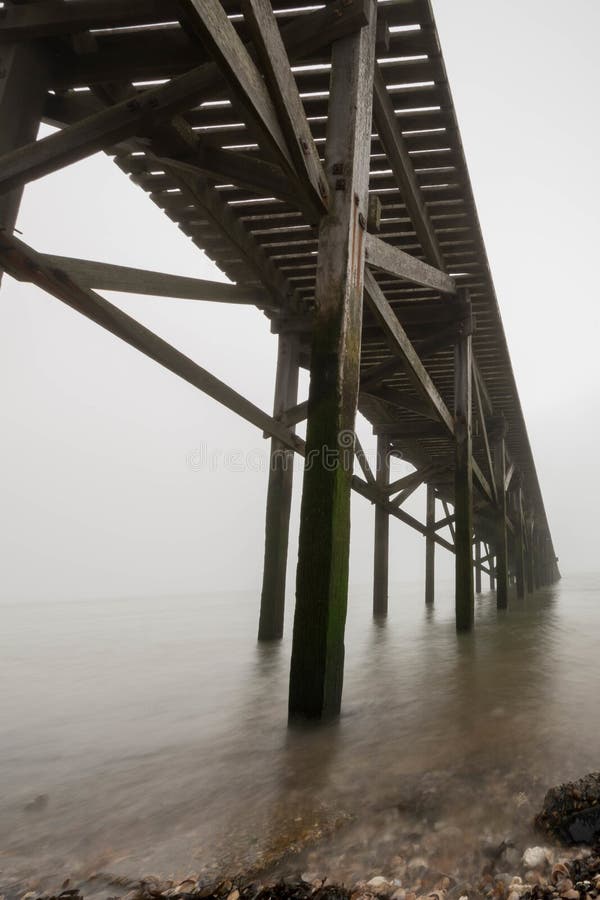 Low Angle Shot of the Wooden Pier Under a Scenic Cloudy Sky Stock Image ...