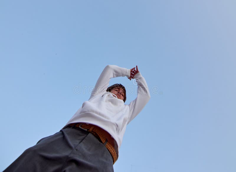 Low Angle Shot of a Young Male Reaching Up on a Windy Day Stock Image ...