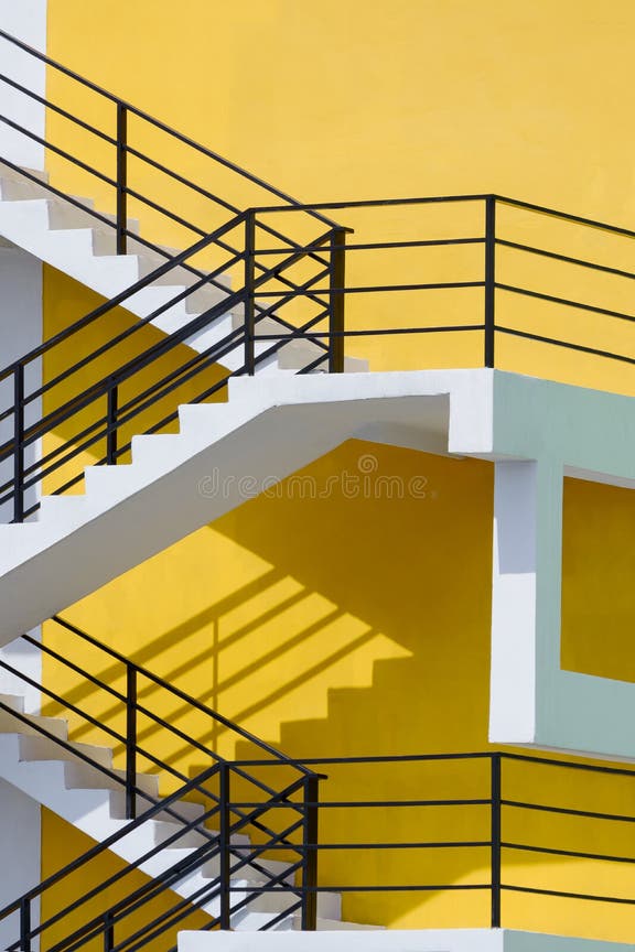 Side View of Fire Escape Outside of Yellow Building Wall in Vertical ...