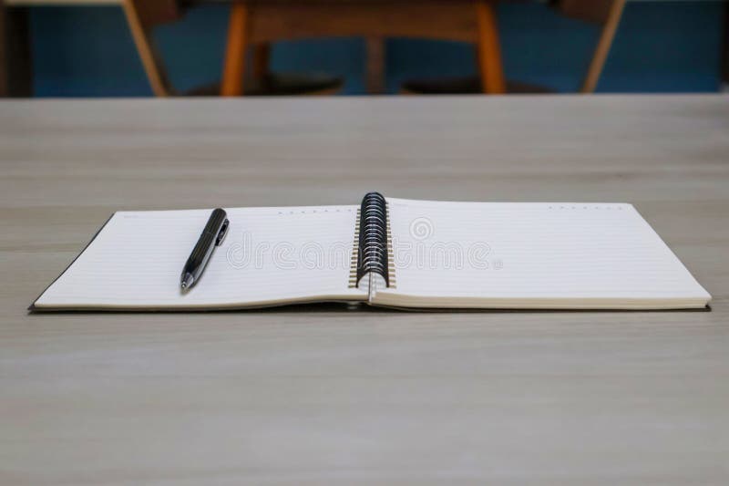 Low Angle Side View. Lined Notebook Page with Pen on Wooden Table ...
