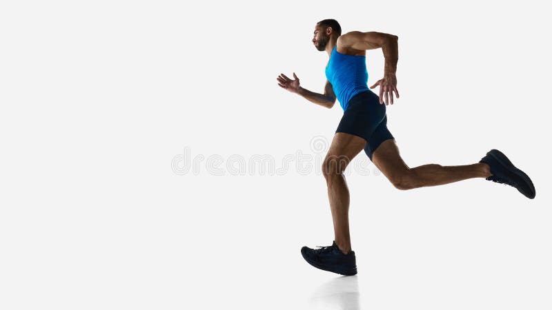 Low Angle Side View of Muscular Man, Runner in Motion, Running ...