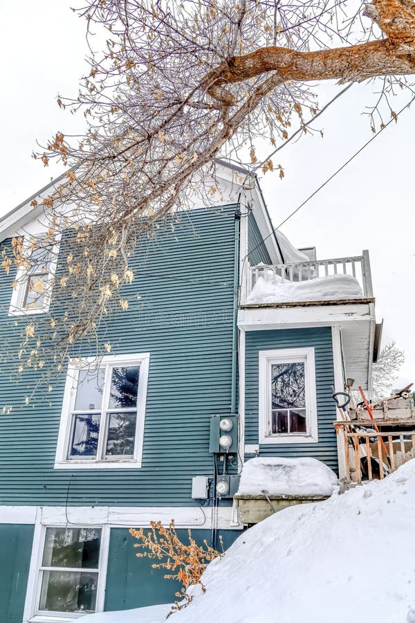 Low Angle Side View of a Three-storey Blue House Covered with Snow ...